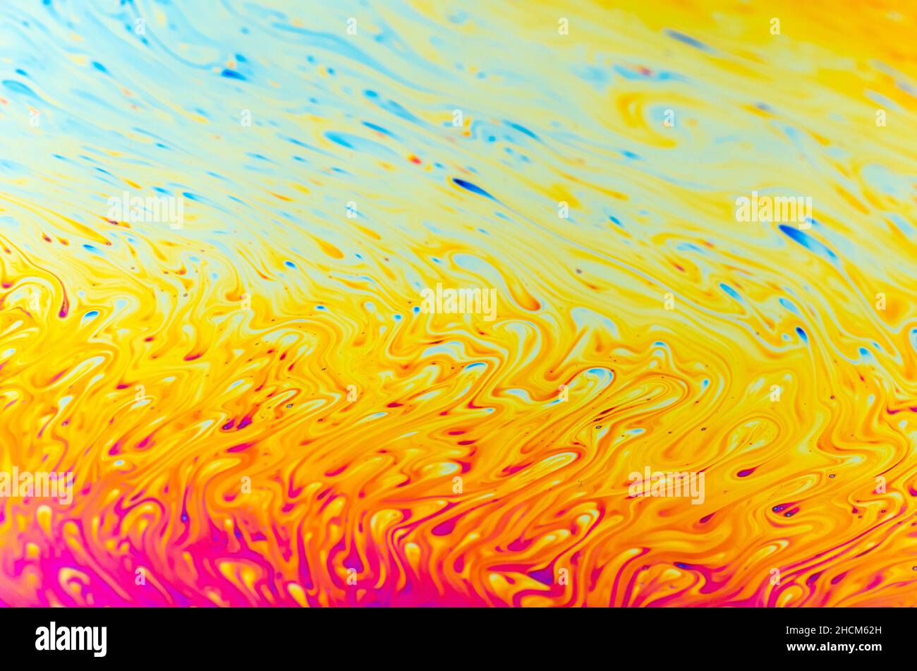 Macro of colorful iridescent flat soap surface with fluid iridescent ...