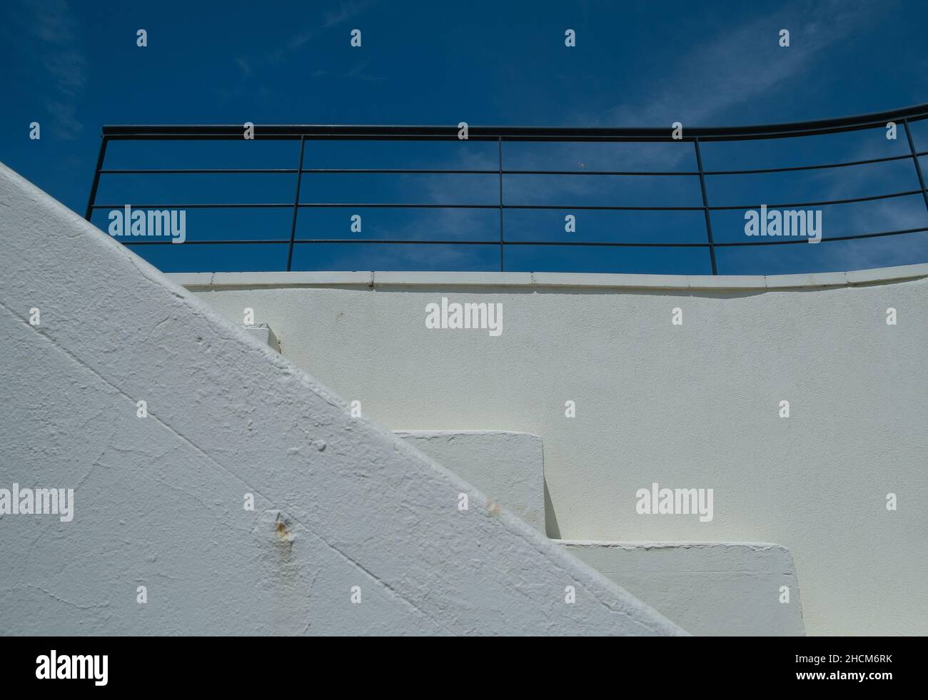 A view of stair (steps) and railings against a blue sky Stock Photo - Alamy