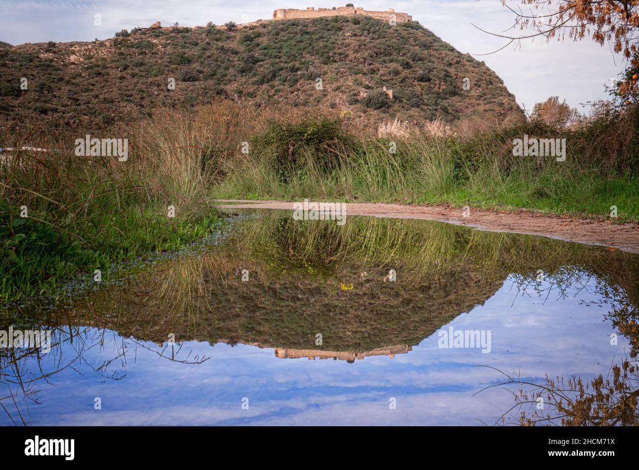 Reflection of the mountain with a castle in a pool of water Stock Photo ...