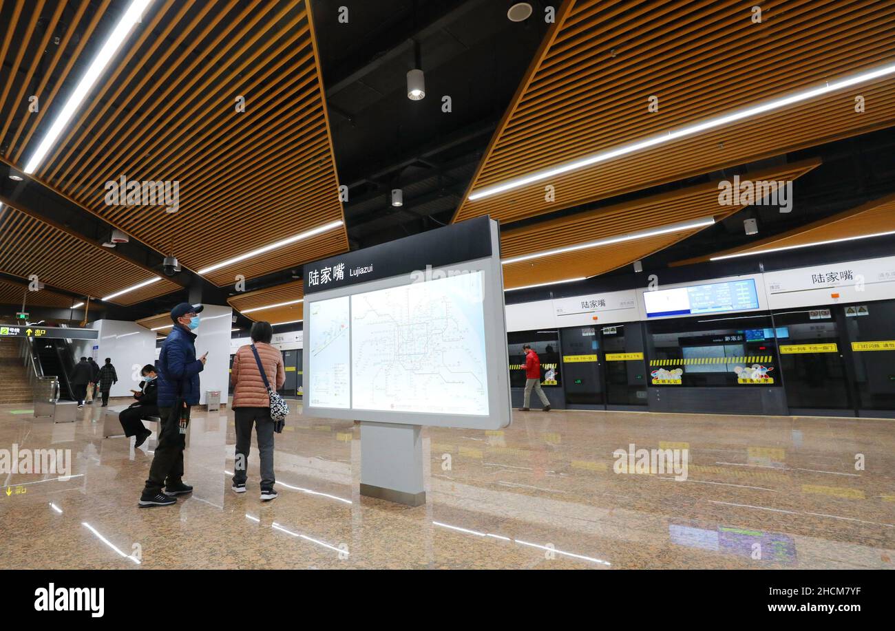 Shanghai. 30th Dec, 2021. Passengers look at a map at Lujiazui Station ...