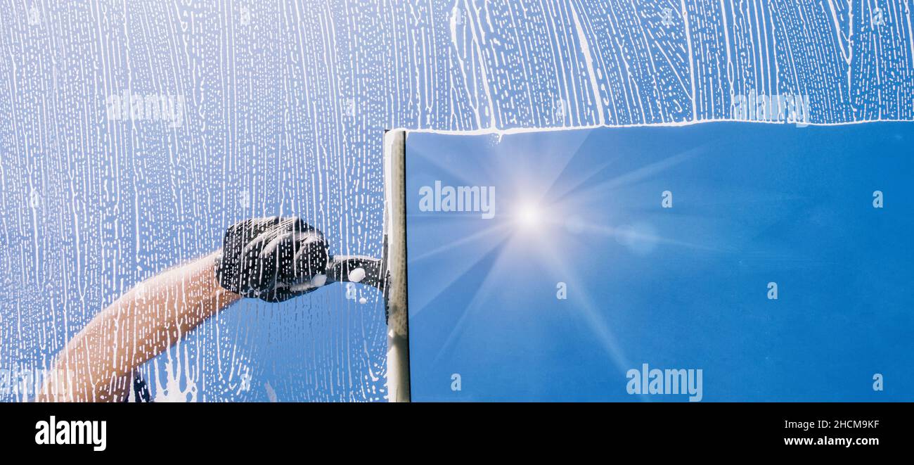 Window cleaner cleans window with foam and puller, banner size Stock ...