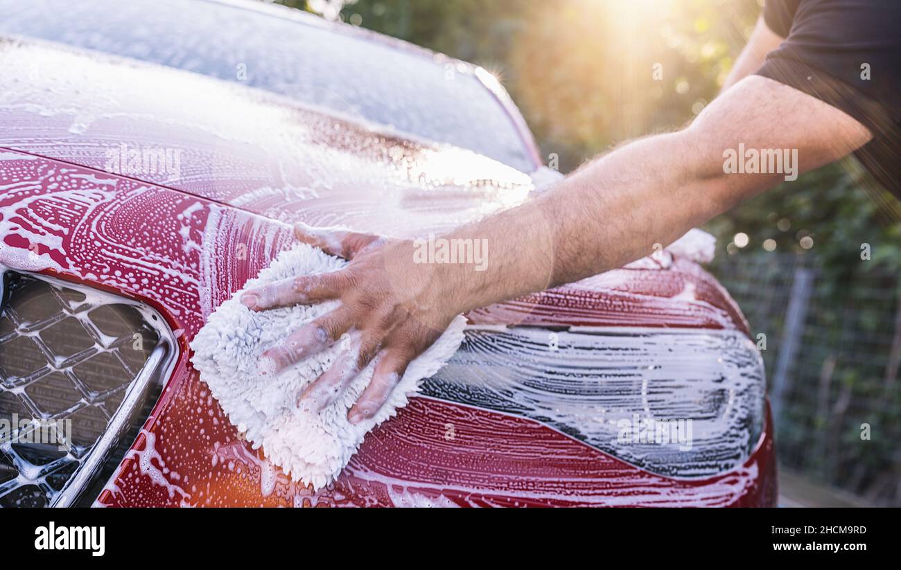 washing red car front with sponge on a car wash Stock Photo - Alamy