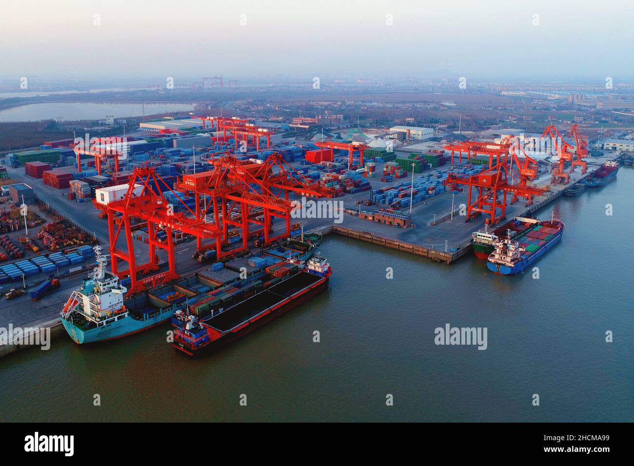 RUGAO, CHINA - DECEMBER 30, 2021 - Machines load and unload materials ...
