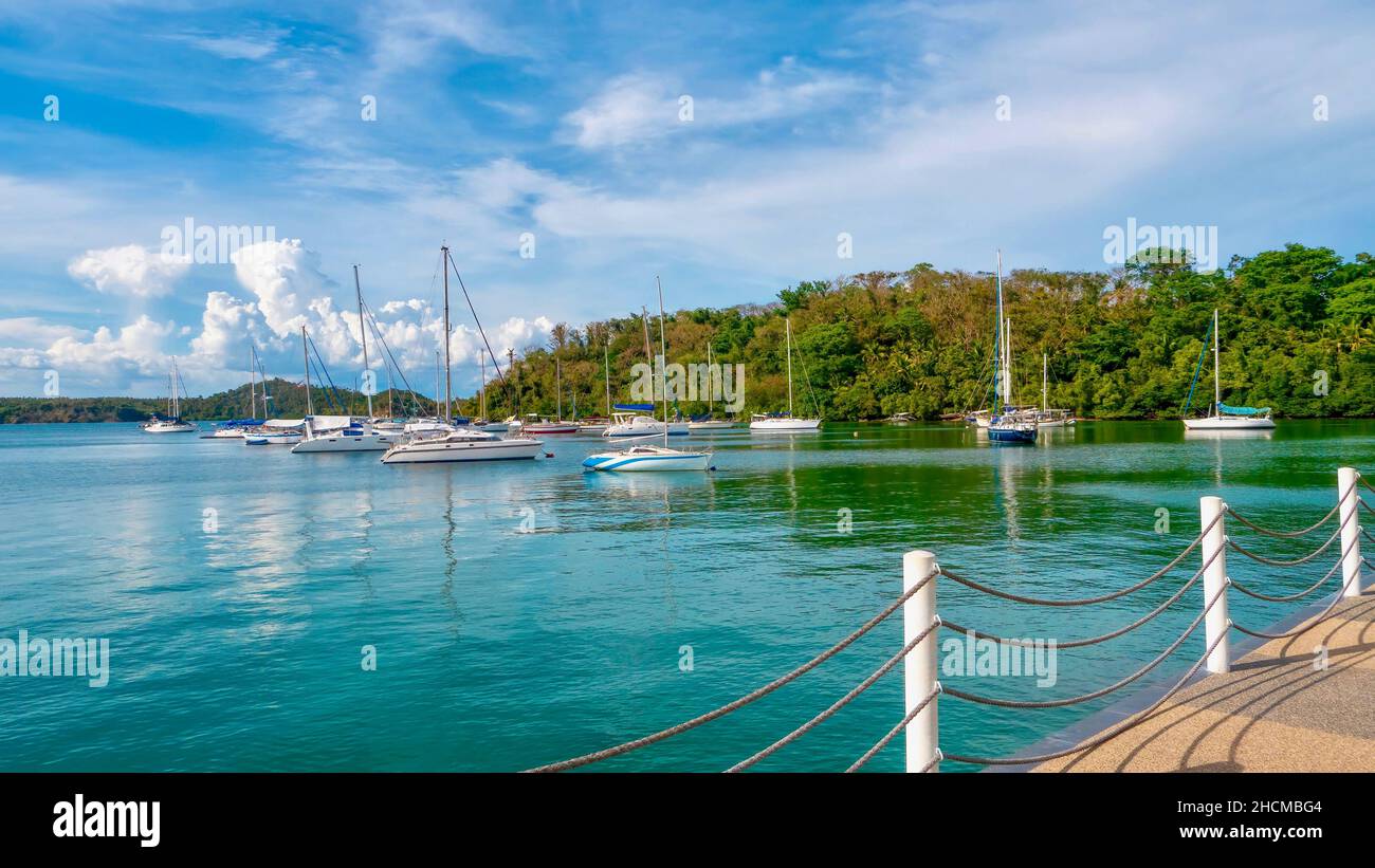 Yachts on moorings in the tranquil waters of Muelle Bay, Puerto Galera ...