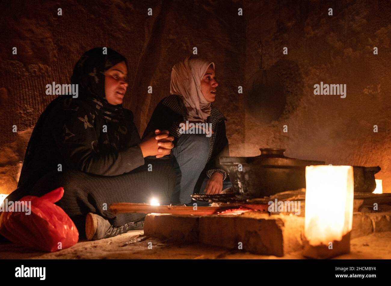 Petra, Jordan. 21st Nov, 2021. Two Bedouins cook over a campfire in a ...
