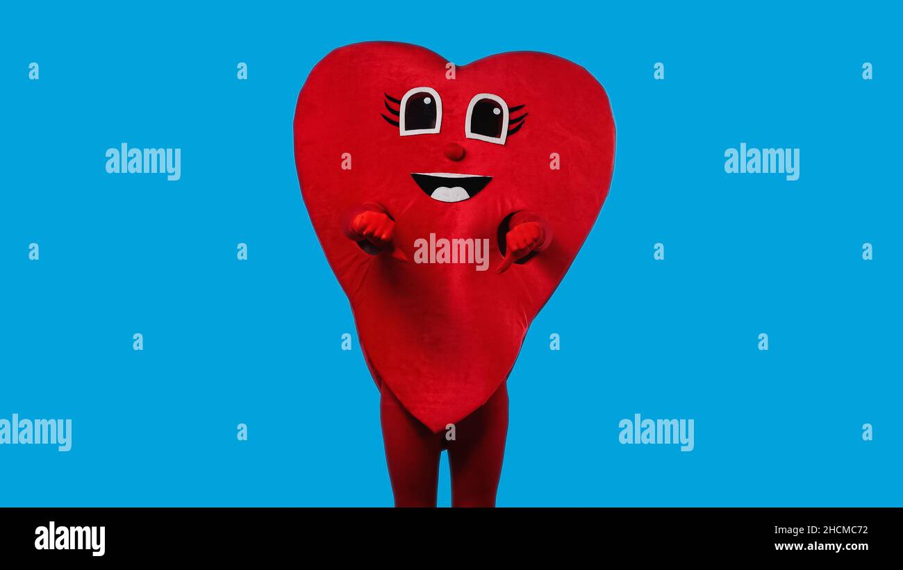 person in red heart costume showing dislike isolated on blue Stock ...