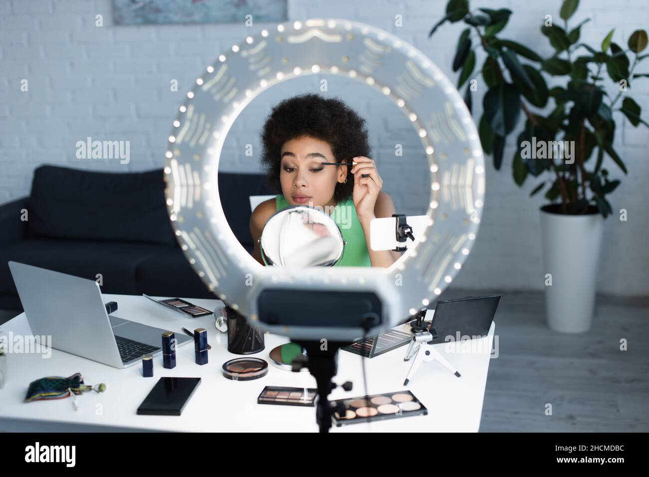 Applying mascara at mirror hi-res stock photography and images - Alamy