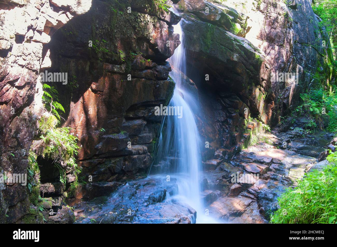 Avalanche falls flowing into flume brook within the steep gorge at the ...