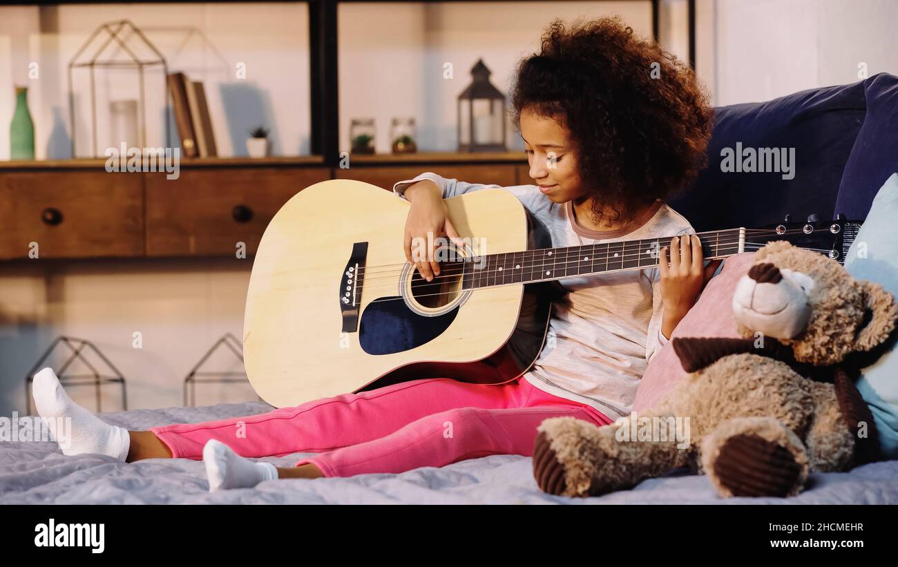 african american child playing acoustic guitar in bedroom Stock Photo ...