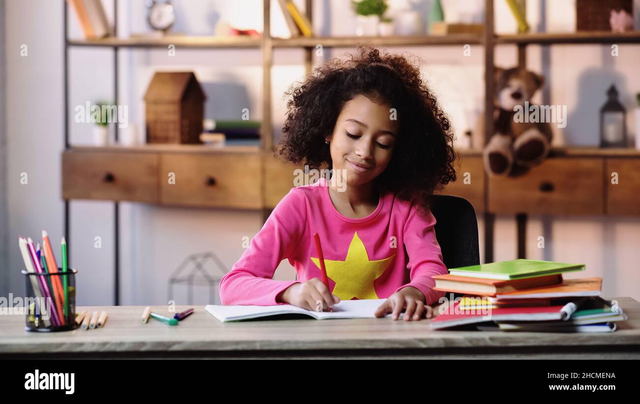 happy african american girl writing in notebook at home Stock Photo - Alamy