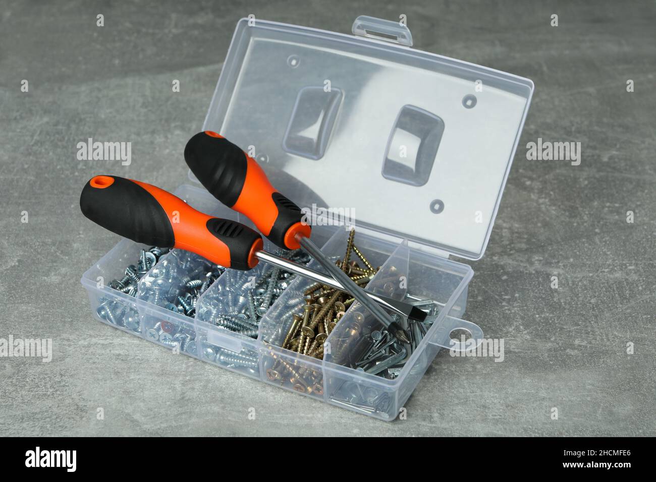 Box with screws and screwdrivers on gray textured background Stock ...