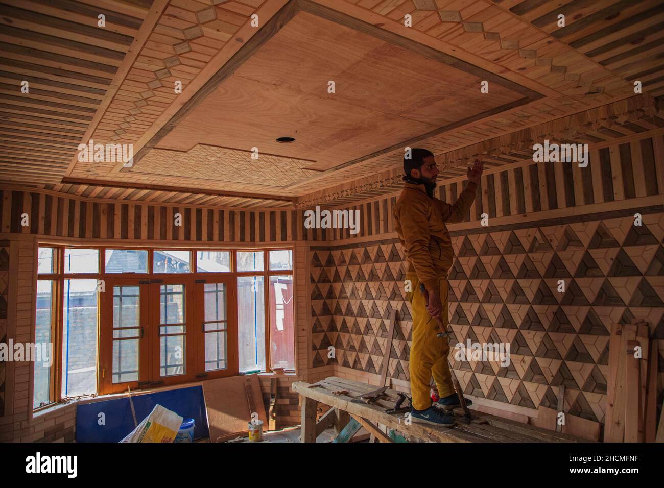 A carpenter install interior panelling at a house on the outskirts ...