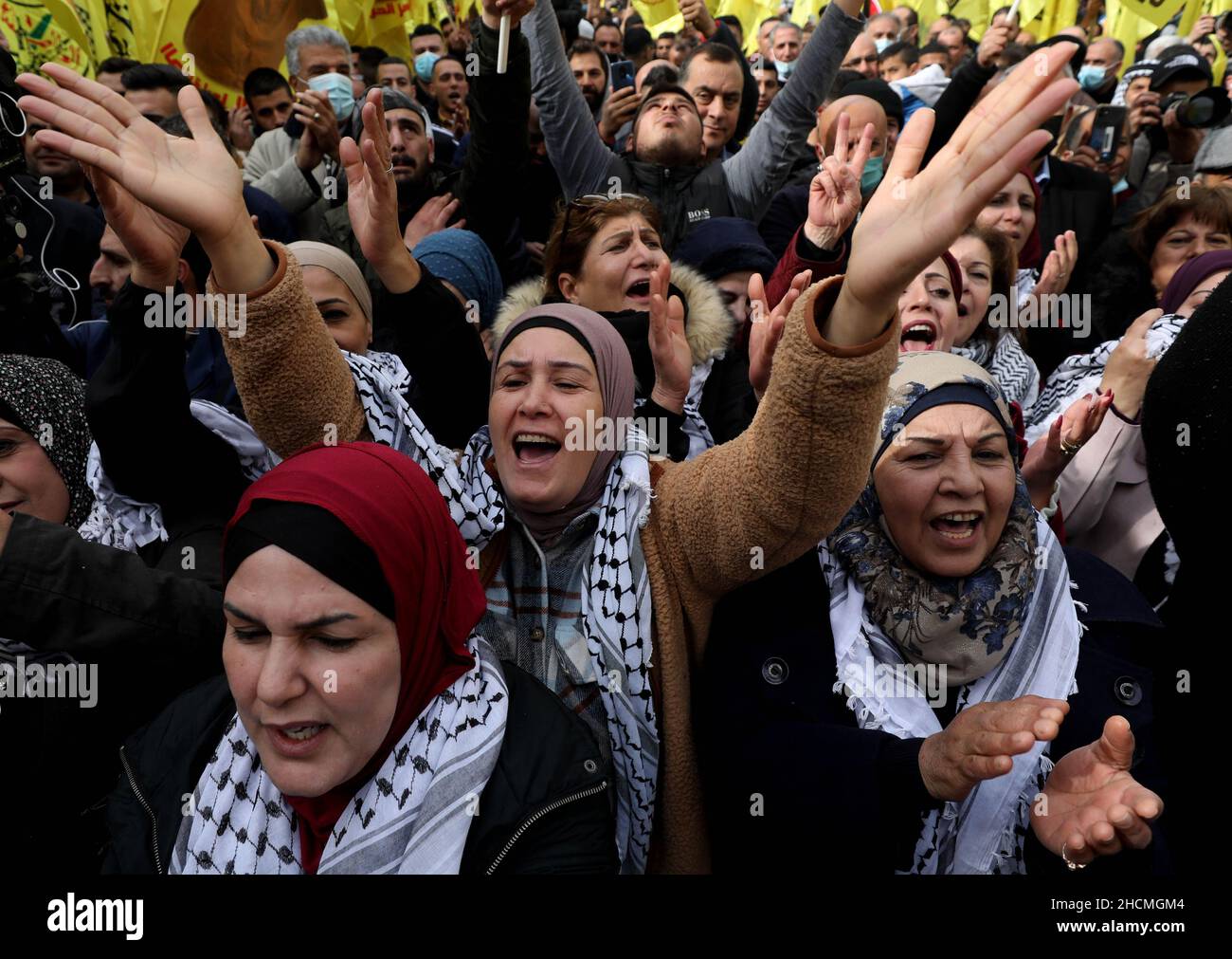 Ramallah. 30th Dec, 2021. People take part in a rally marking the 57th ...