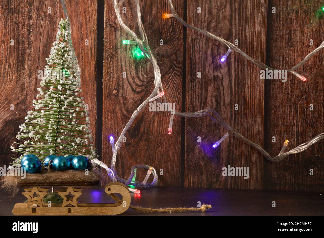 Christmas tree with sleigh, blue spheres and lights Stock Photo - Alamy