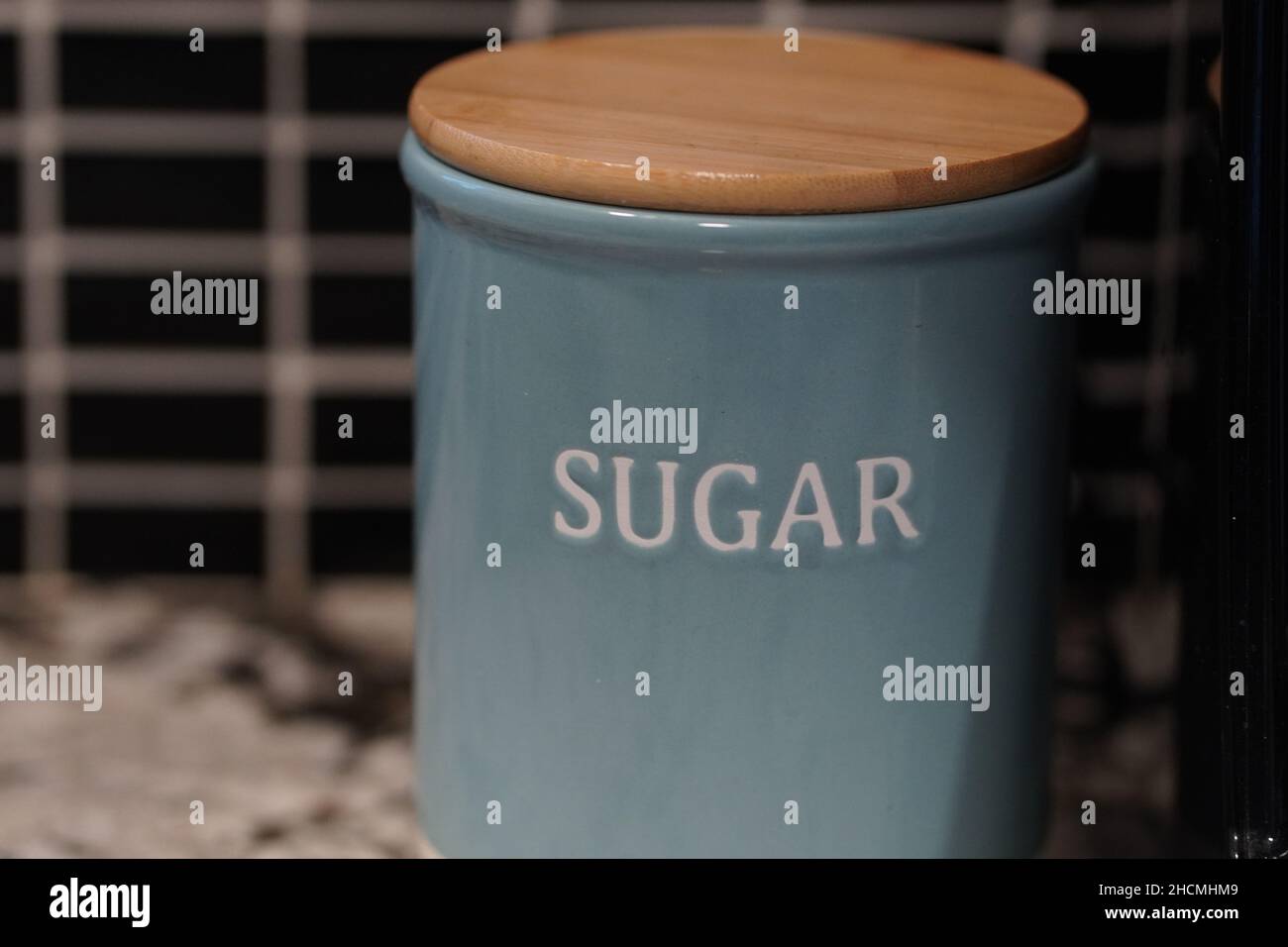Closeup focus of a light blue ceramic sugar jar with a wooden lid Stock ...