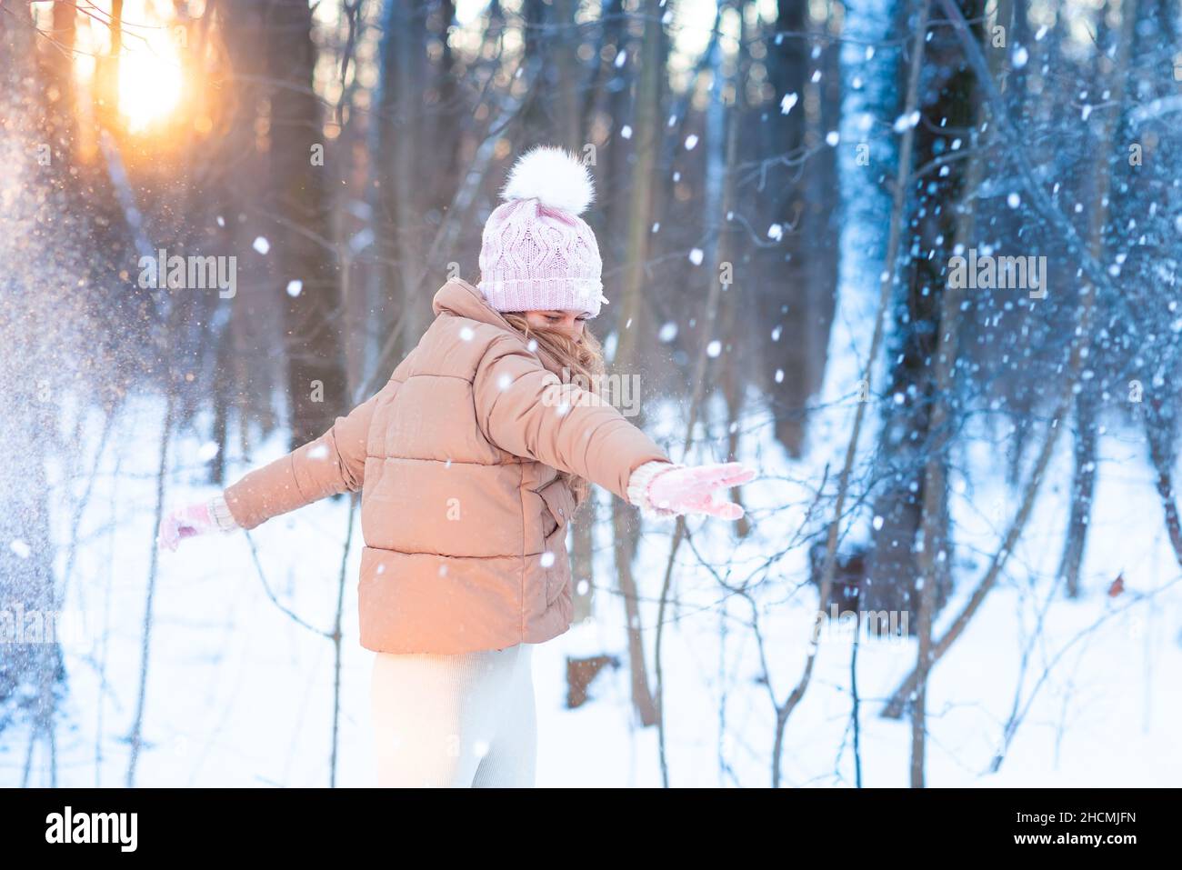 Cute little teenage girl having fun playing with snowballs, ready to ...