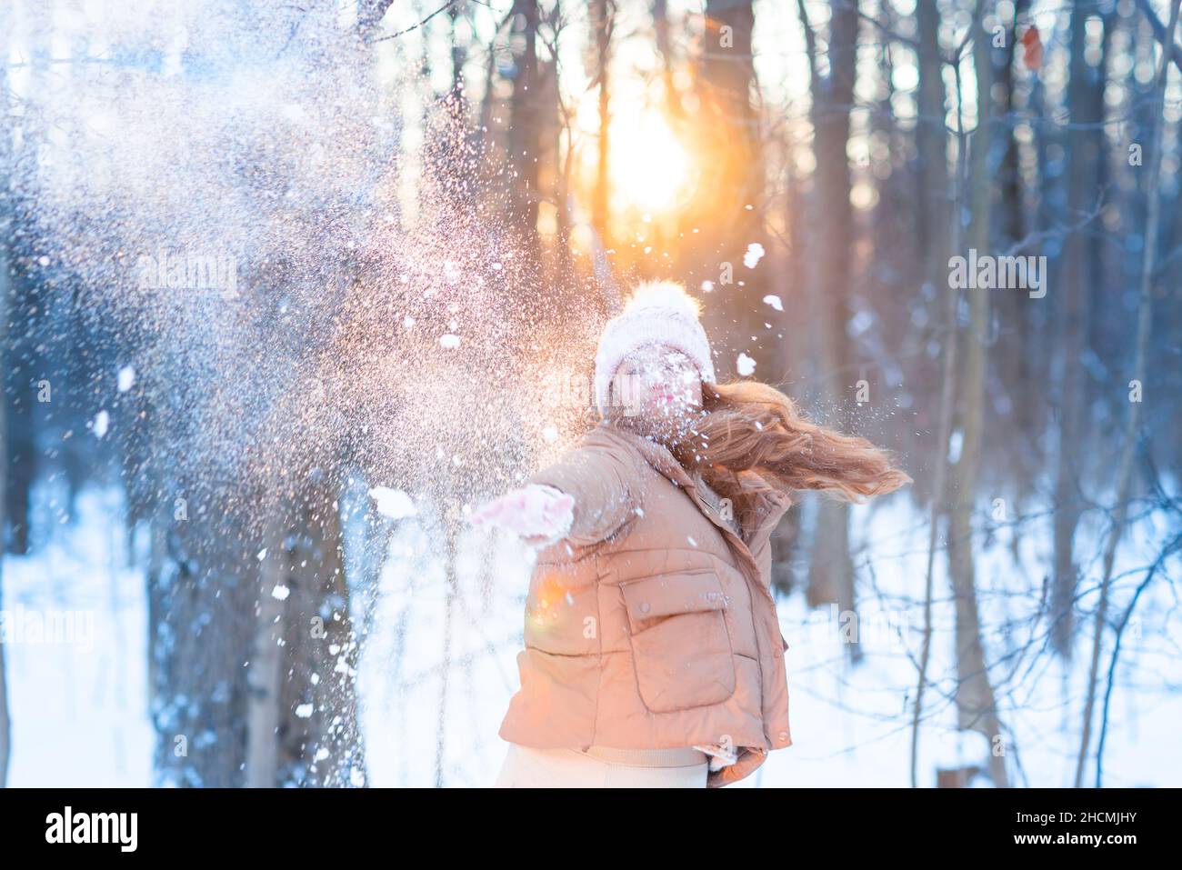 Cute little teenage girl having fun playing with snowballs, ready to ...