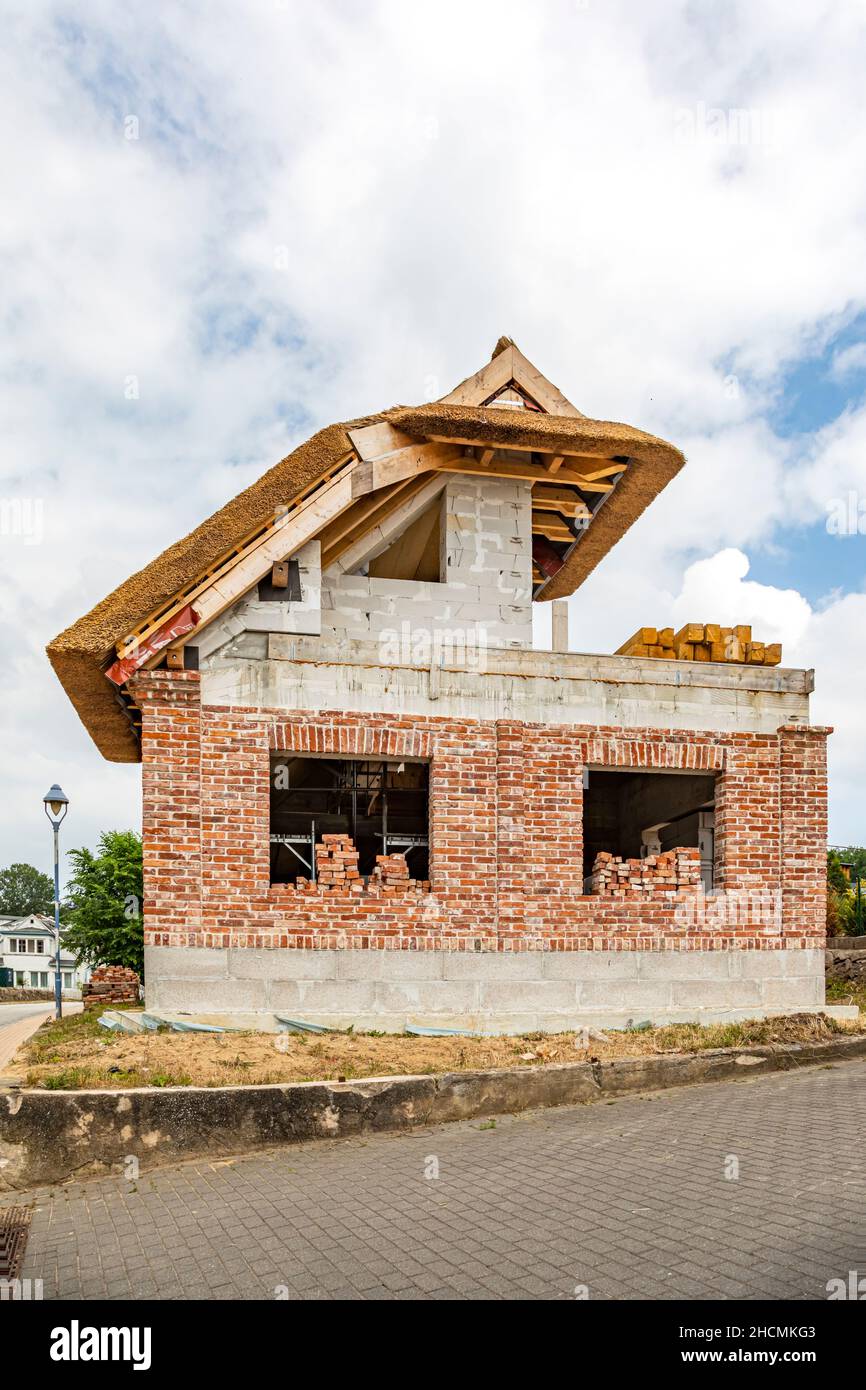 Shell Construction Of A Small Residential House With Thatched Roof And ...