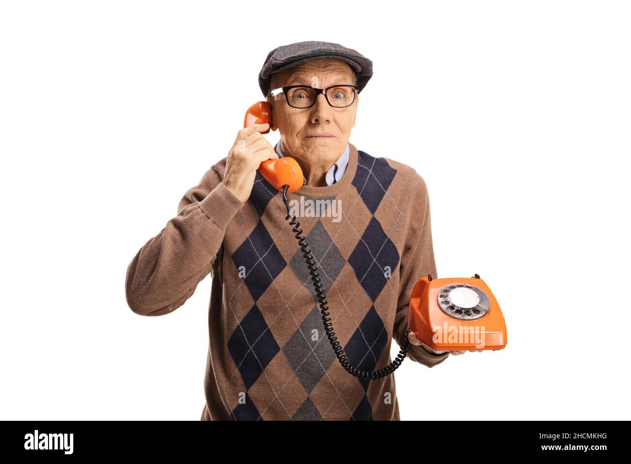 Elderly man making a phone call with an old vintage rotary phone ...