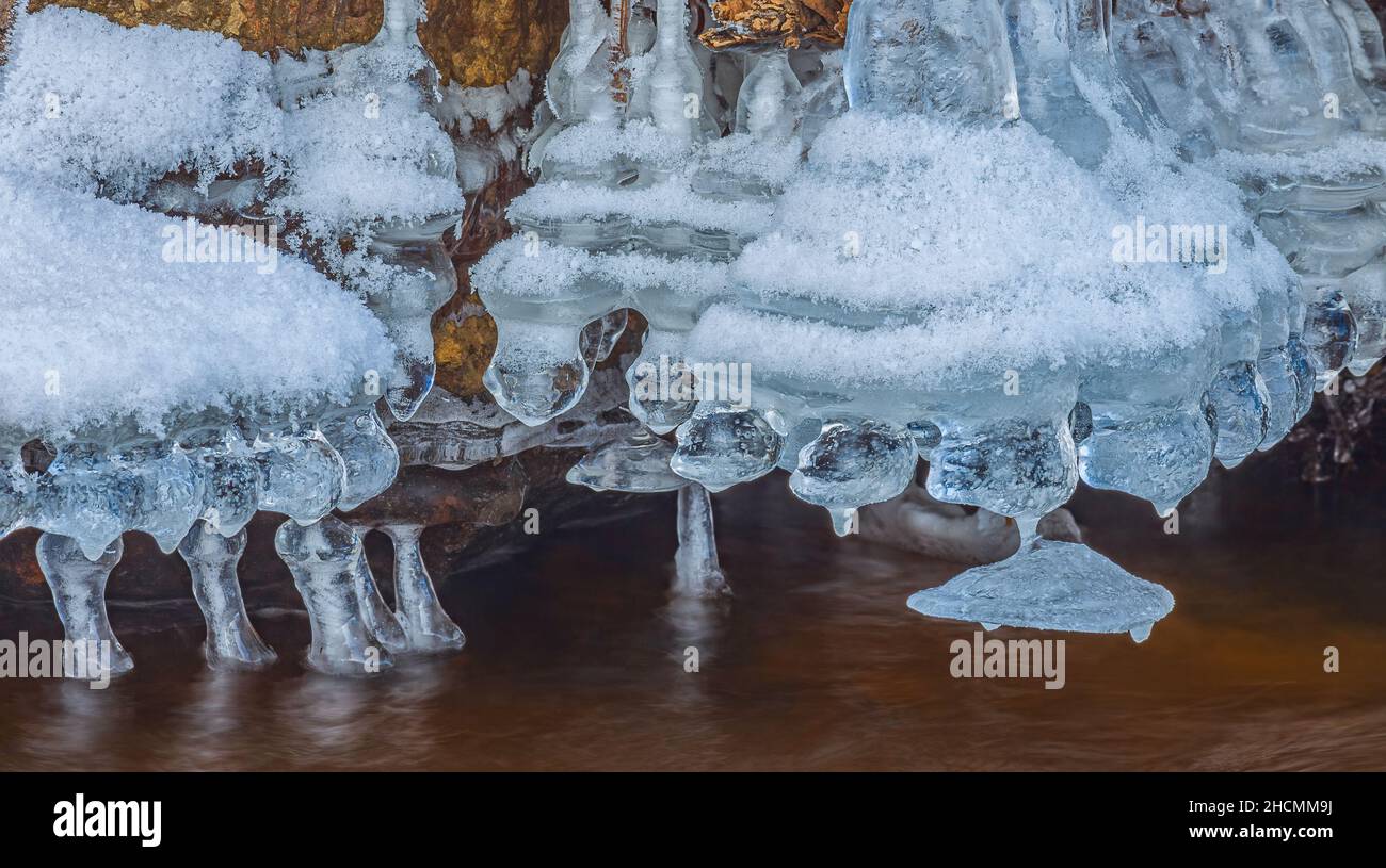 Icicles over the water in the river. Natural landscape. Winter ...