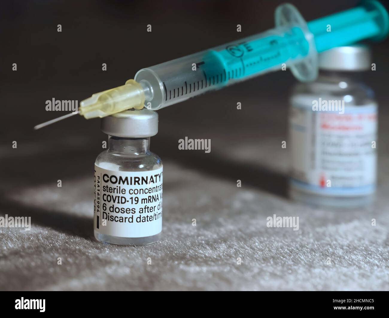 Isolated Moderna spikevax and Comirnaty Biontechampoule with a syringe ...