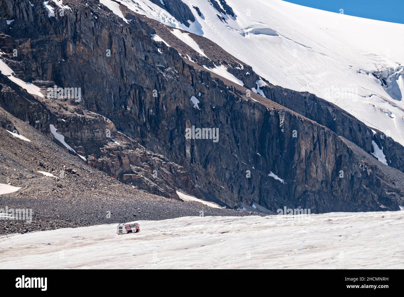 Tourists on Ice Explorer transporter appear tiny on the massive the ...