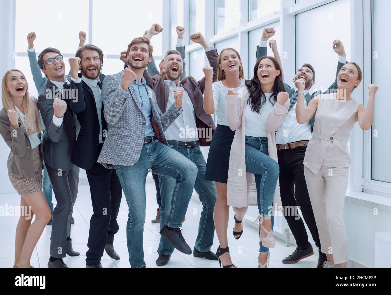 Successful business team celebrating with arms up Stock Photo - Alamy
