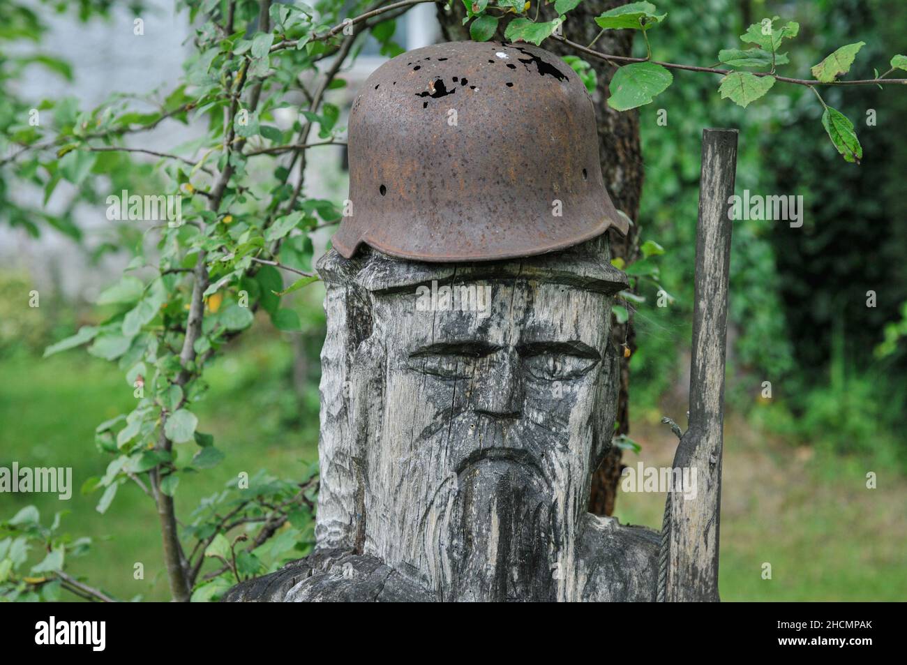 Old wooden sculpture with a human face with a rusty broken hat Stock ...