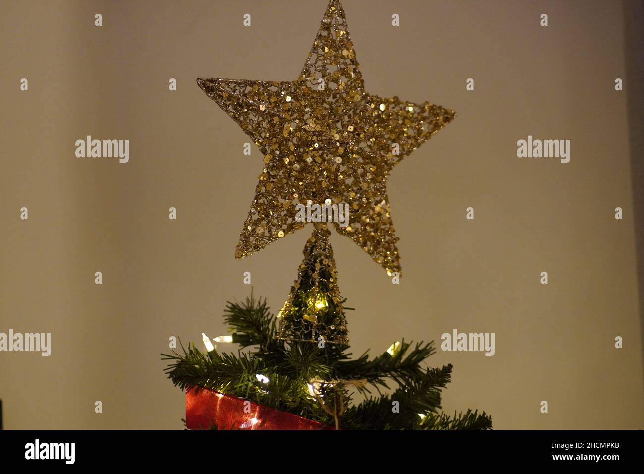 Photo of a glittery Christmas star on a Christmas tree Stock Photo - Alamy