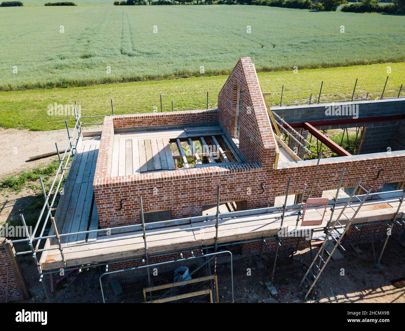 Up close aerial drone view of a barn conversation showing scaffolding ...