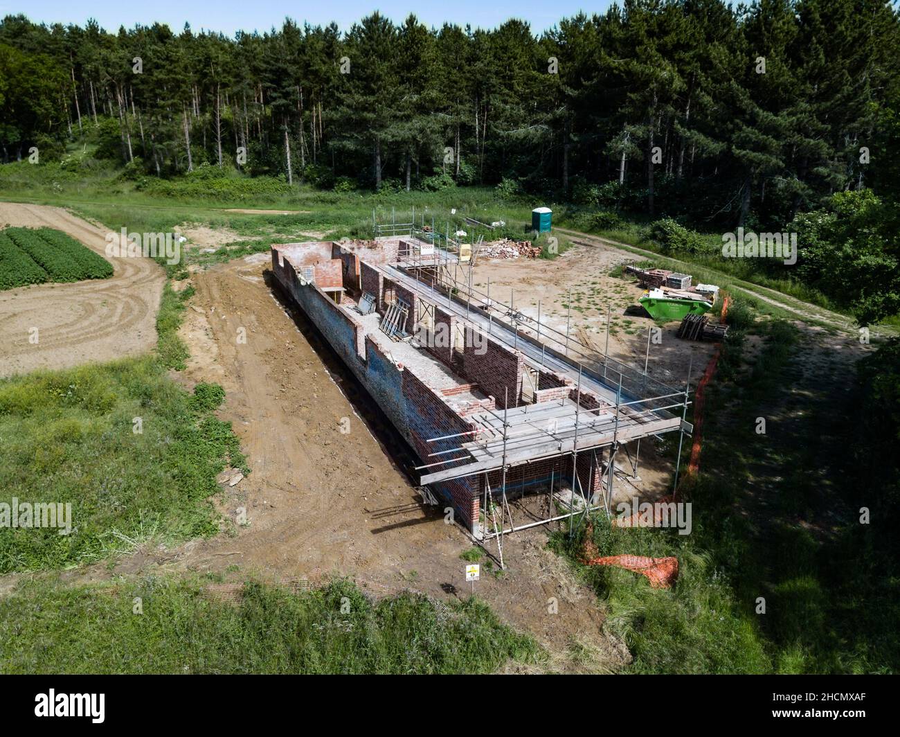 Aerial view of a partly converted barn or farm building showing ...