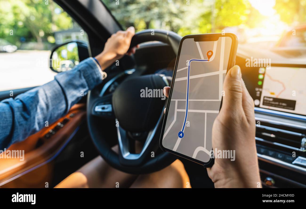 Tourist using GPS map navigation app on smartphone screen to get ...