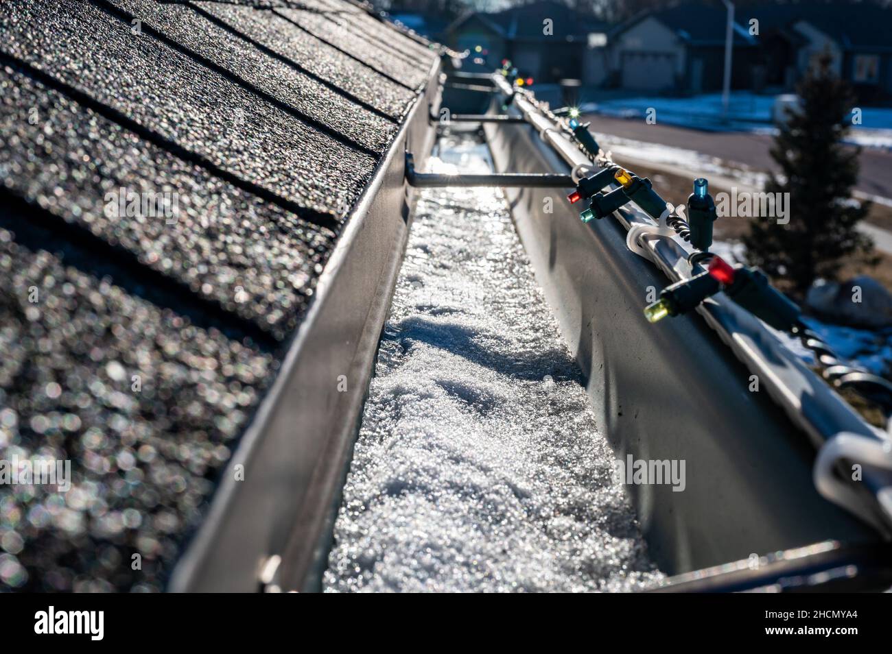 Ice and snow building up inside a rooftop gutter system on a ...