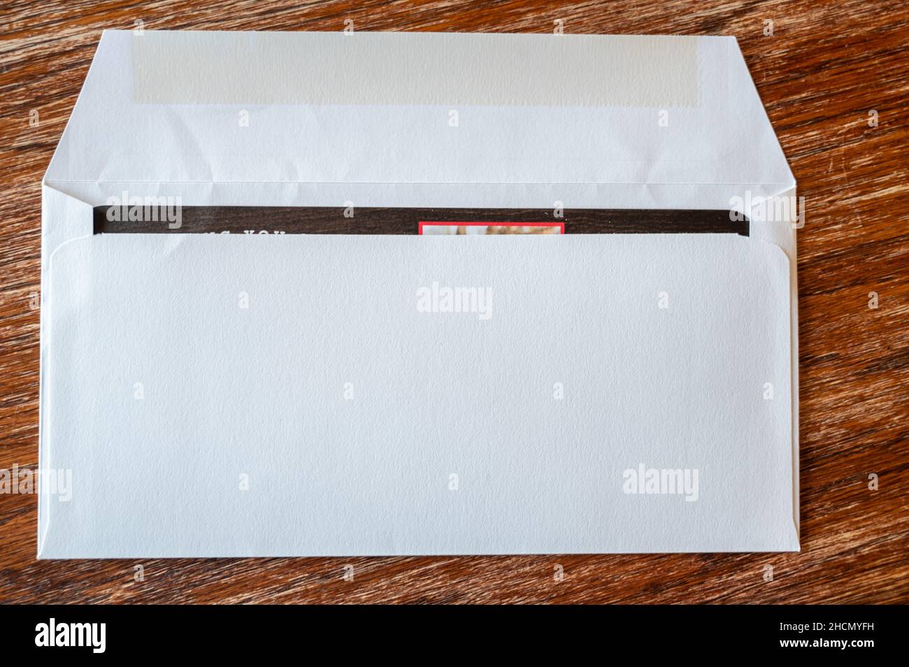 blank envelope ready to be sealed and sent in the mail. Dark colored ...