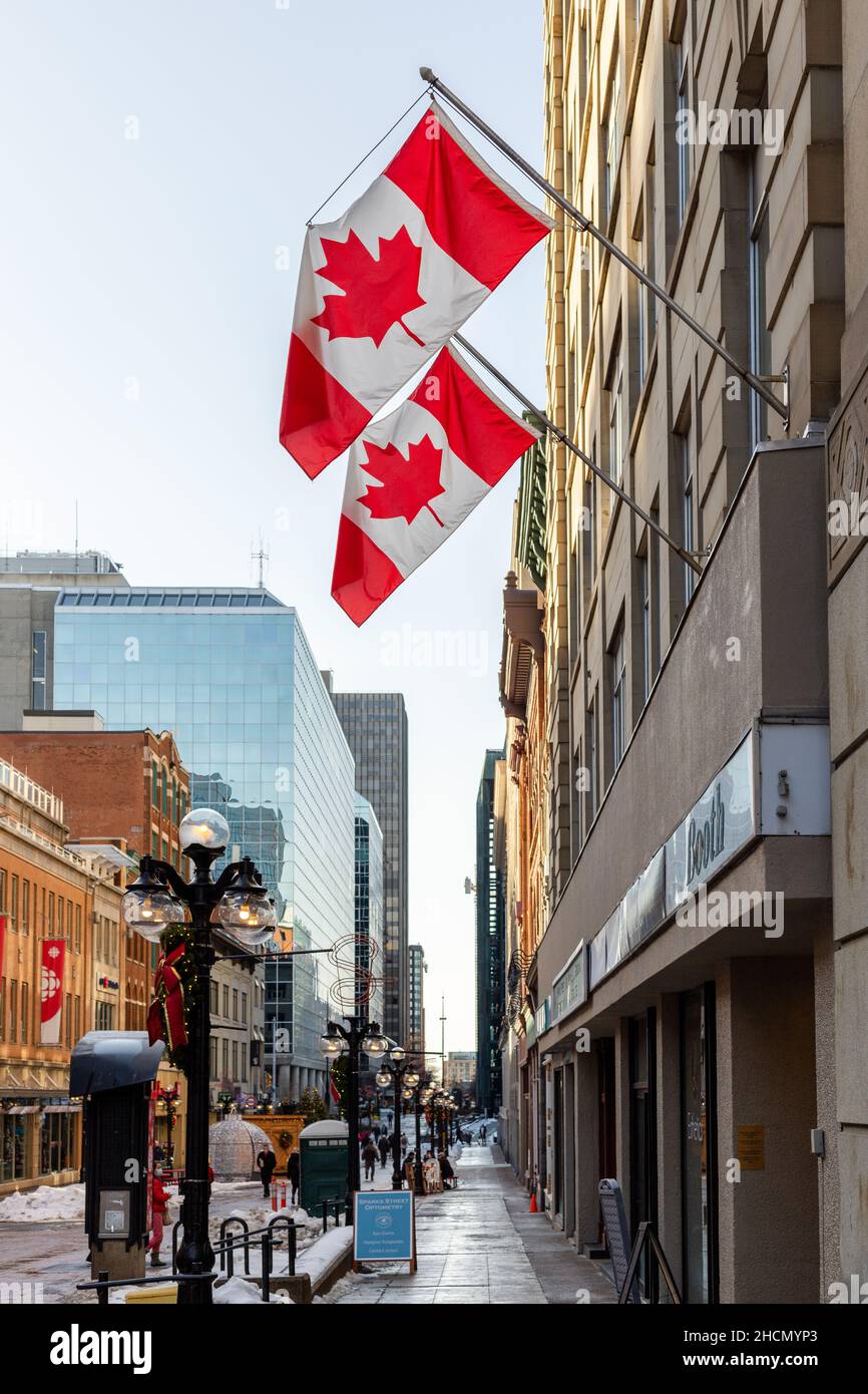 Ottawa, Canada - December 16, 2021: Cityscape street view with canadian flags on buildings in ...