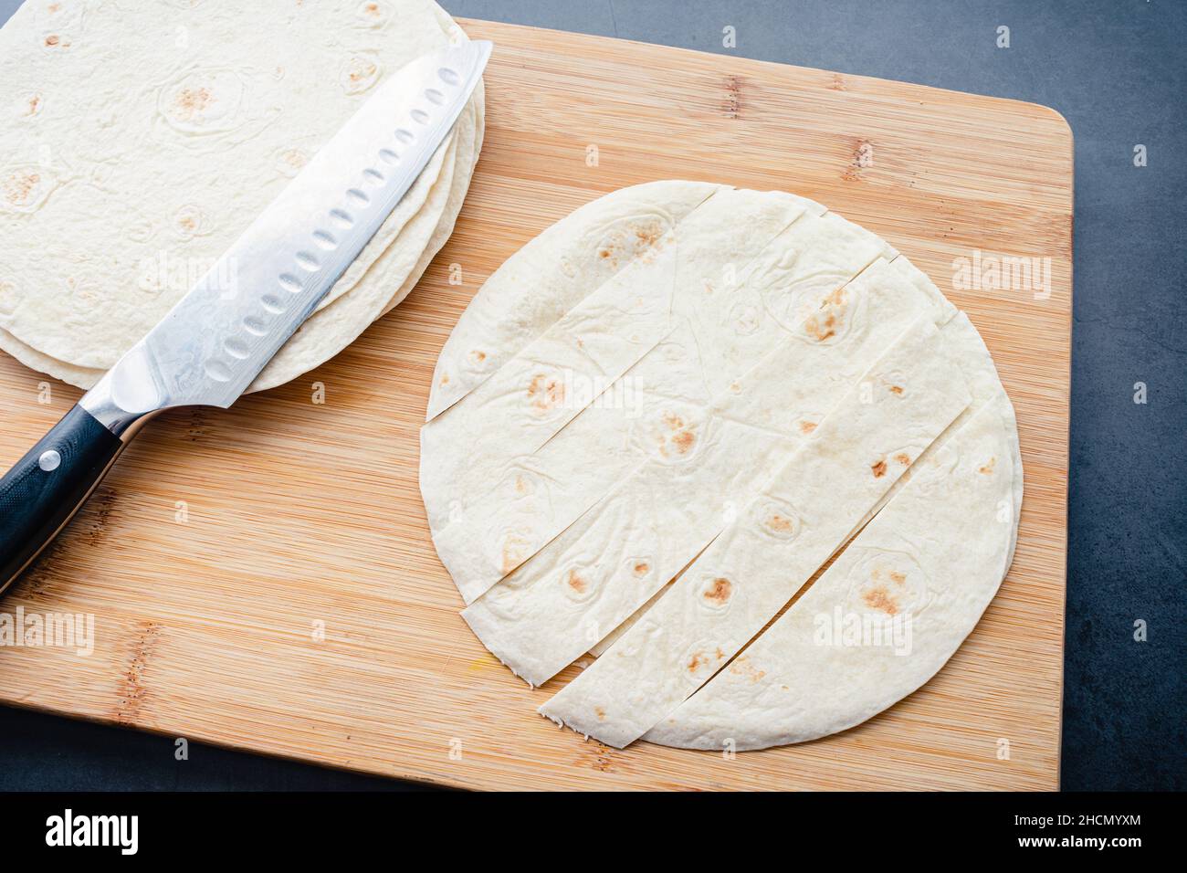 Cutting Flour Tortillas Into Strips on a Bamboo Cutting Board: Cutting ...
