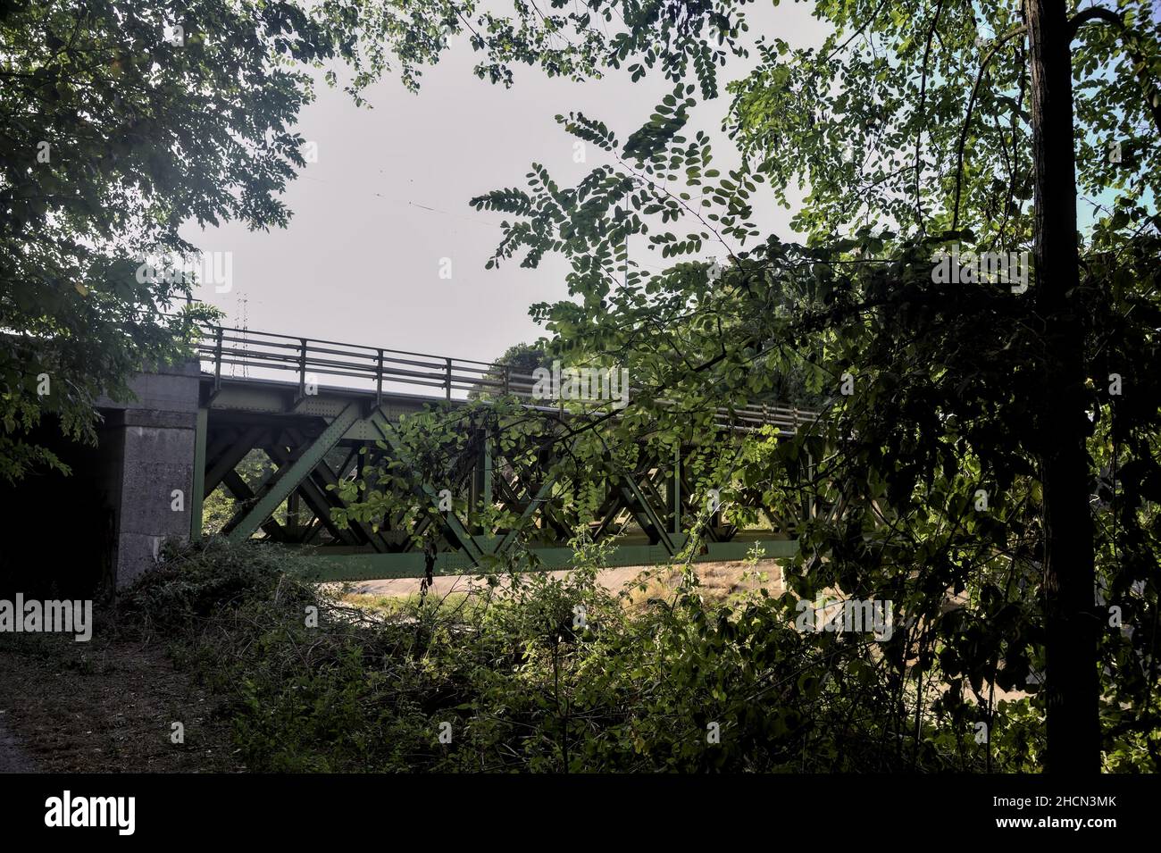 Path that leads to a passage under a railway bridge by the edge of an ...