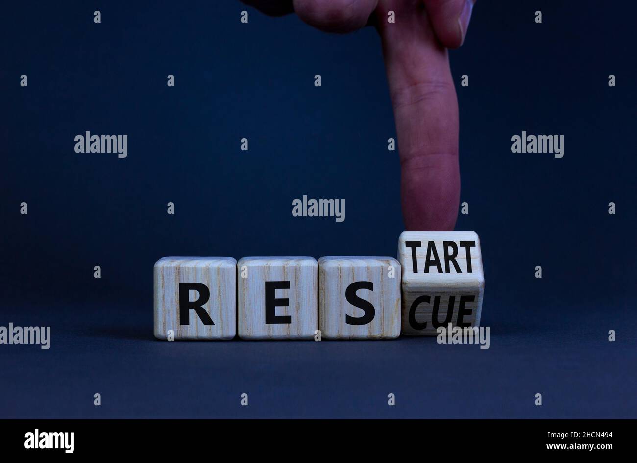 Rescue and restart symbol. Businessman turns a wooden cube and changes ...