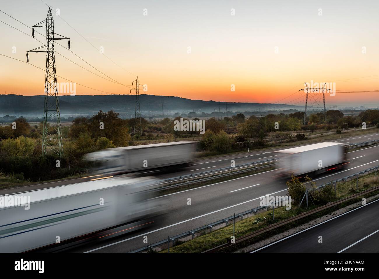High spped blurred highway traffic with Delivery Lorry trucks passing ...