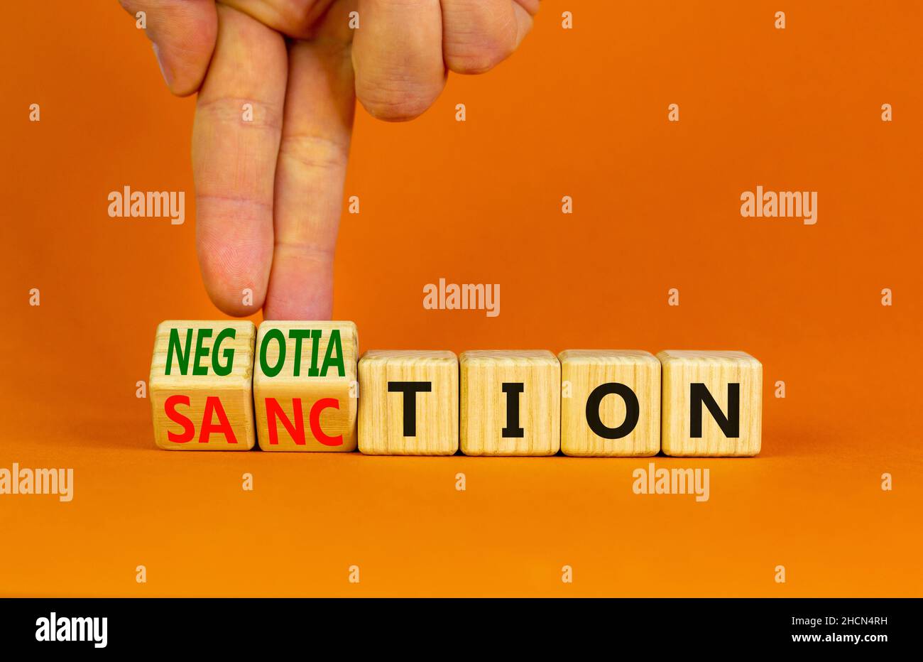 Sanction or negotiation symbol. Businessman turns cubes, changes the ...
