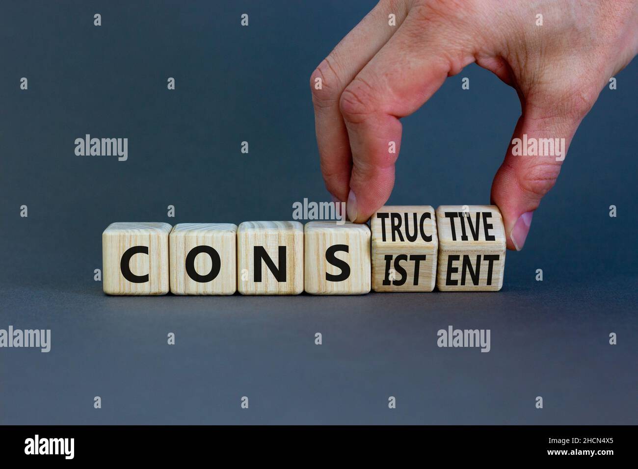 Constructive or consistent symbol. Businessman turns cubes, changes the ...