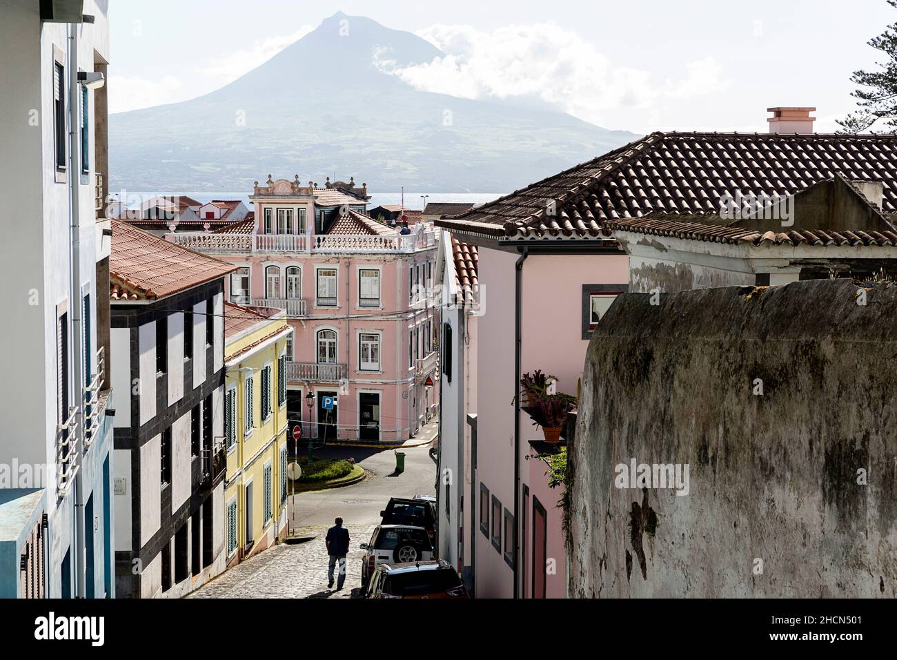 Narrow cobbled streets in the town of Horta vith the view of Mount Pico ...