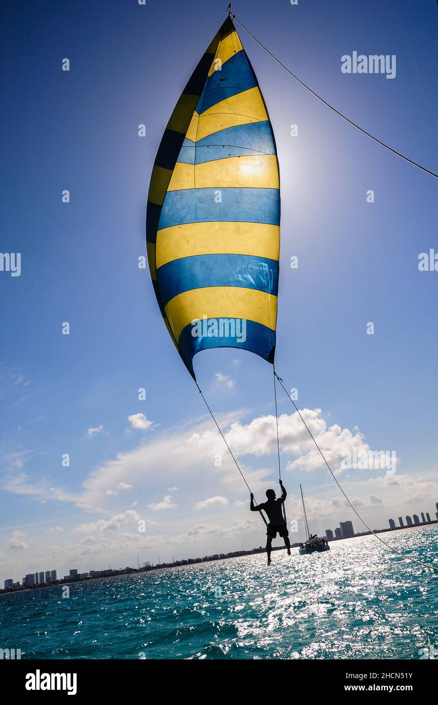 Tourist enjoying his ride on a kind of kite with seat over the ...