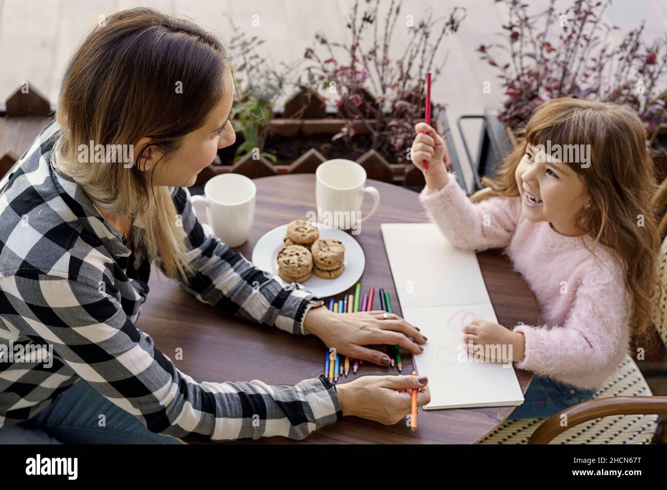 Mother And Daughter Drawing With The Pencils. Mom Helping Her Child ...