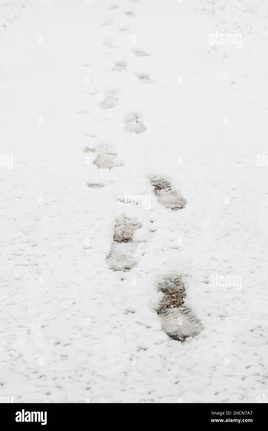 Frozen Footsteps on Snowy Sidewalk Stock Photo - Alamy