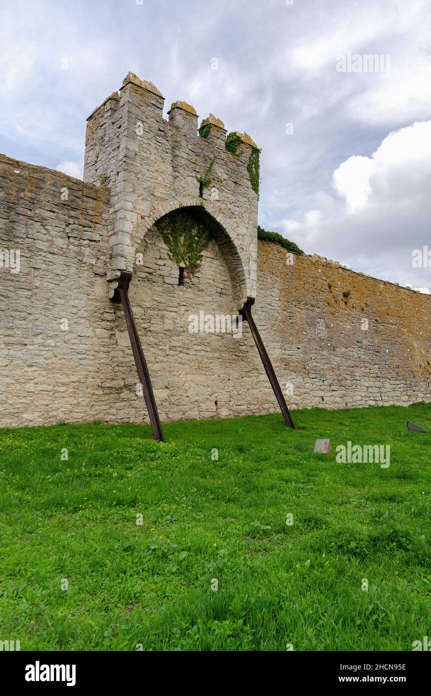 Outside view of a Saddle Tower supported by iron rods in Visby City ...