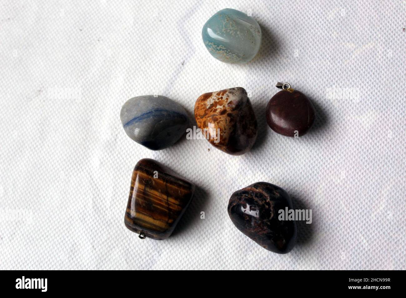 Semiprecious stones on a table with white background Stock Photo - Alamy