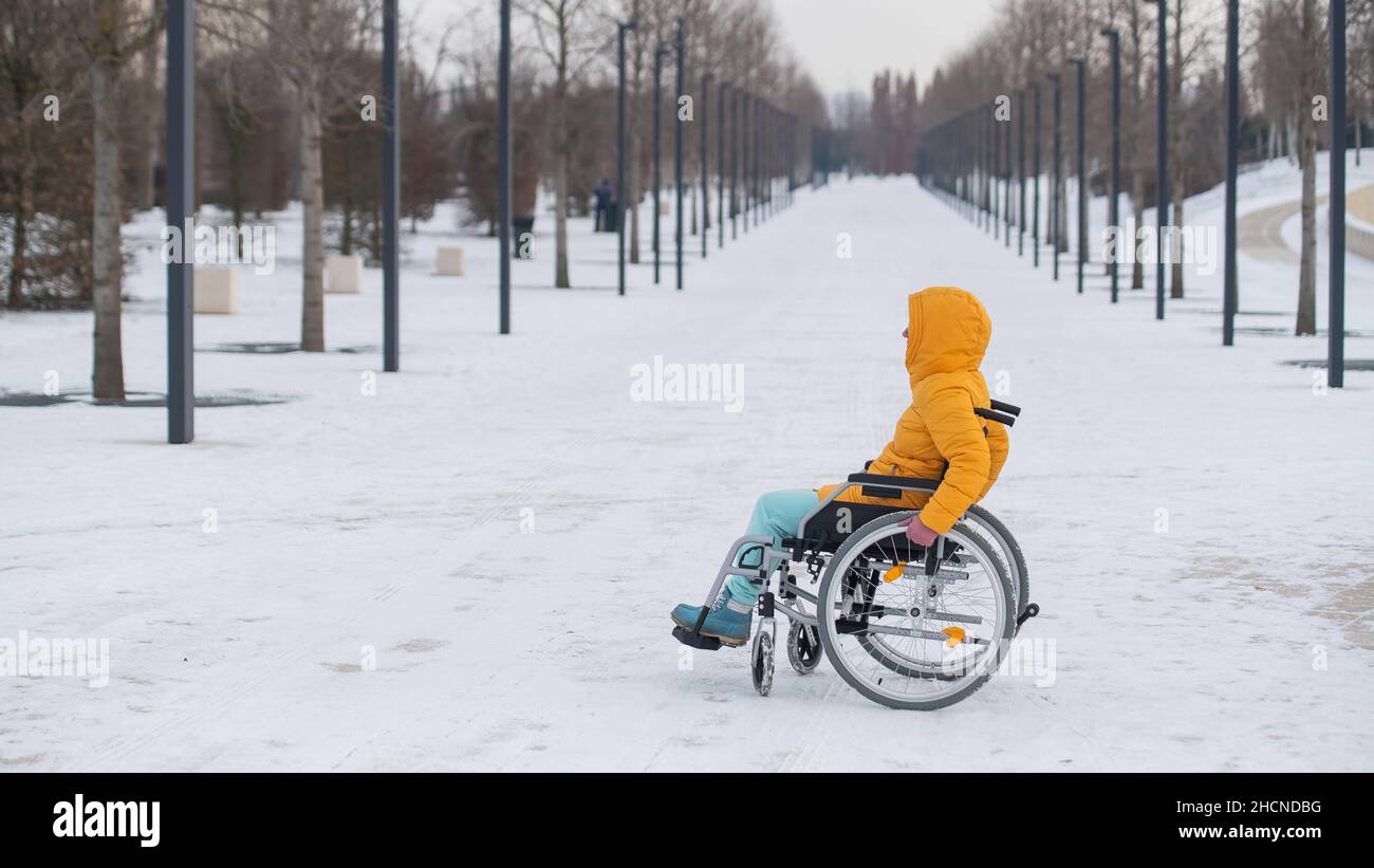 Disabled woman in a wheelchair outdoors in winter Stock Photo - Alamy