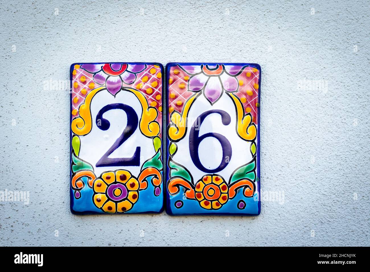 26 painted on tiles with flower as a house number Stock Photo - Alamy