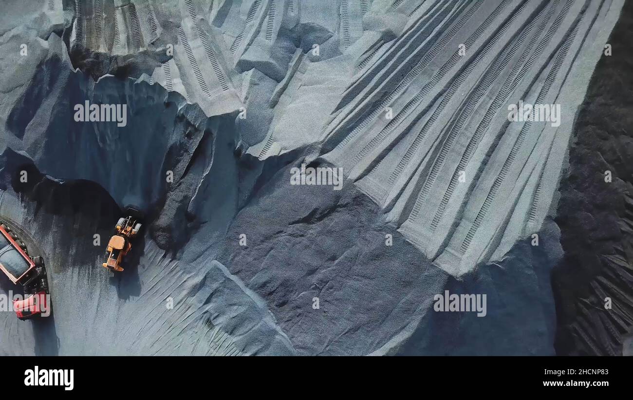 Aerial top view of quarry during work hours. Industrial background with ...